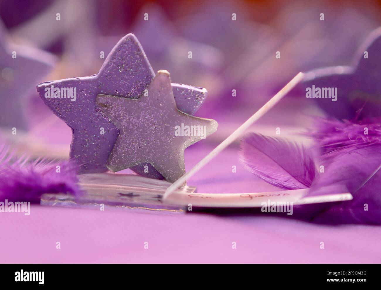 purple background with stars and feathers Stock Photo - Alamy