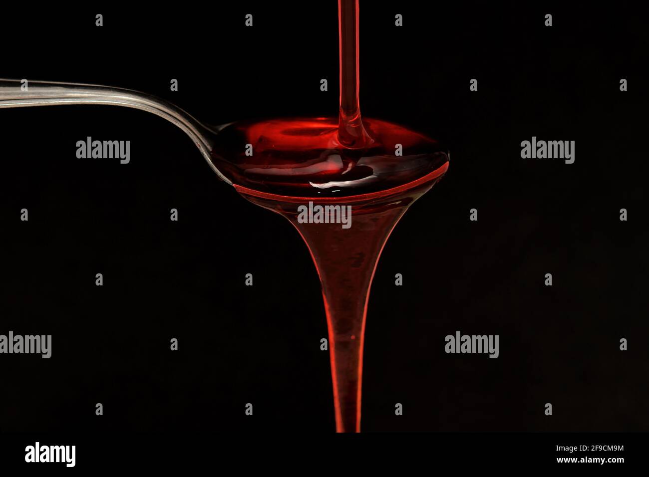 syrup spilling into a spoon Stock Photo - Alamy