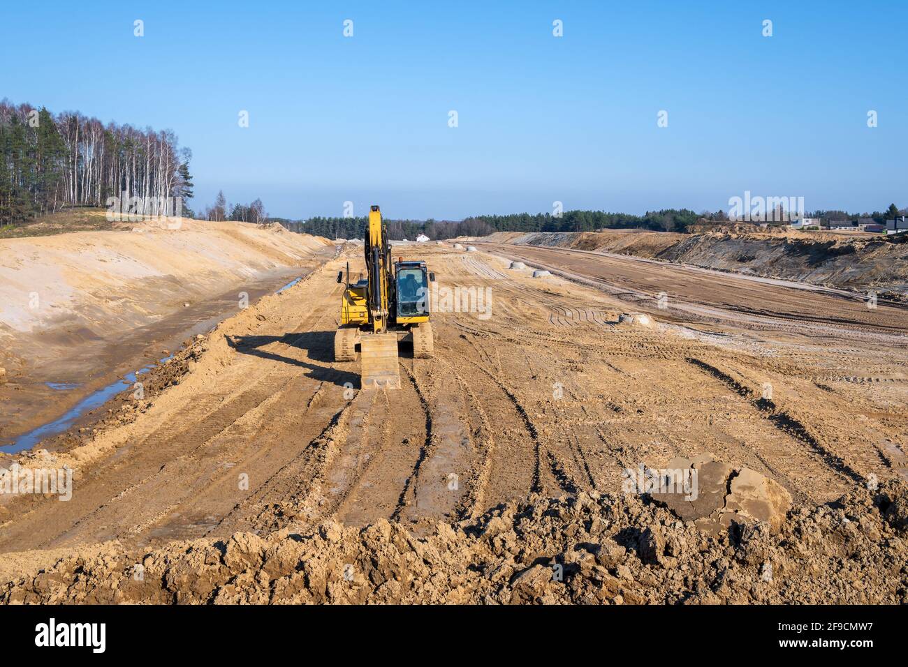 Excavator on a highway construction site. Road construction work Stock ...