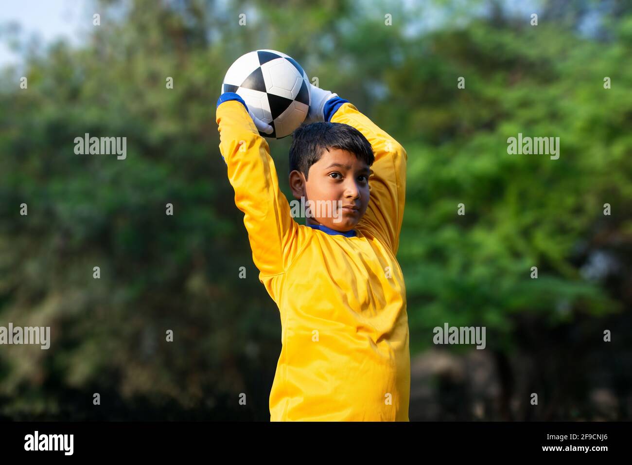 Kid holding football asia hi-res stock photography and images - Alamy
