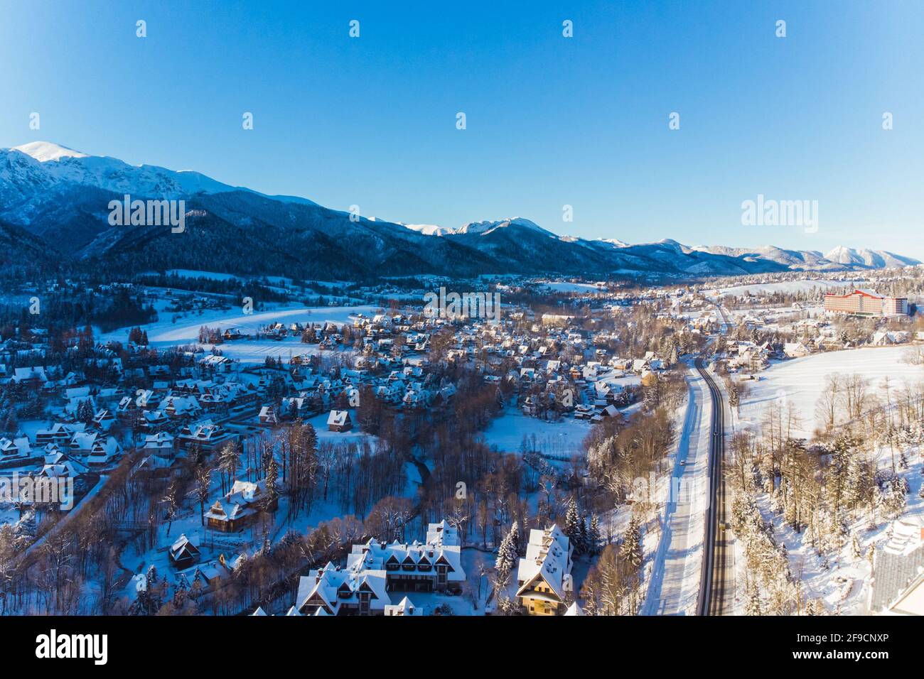 Winter season in Zakopane, Poland. Snow covered houses roads and forest ...
