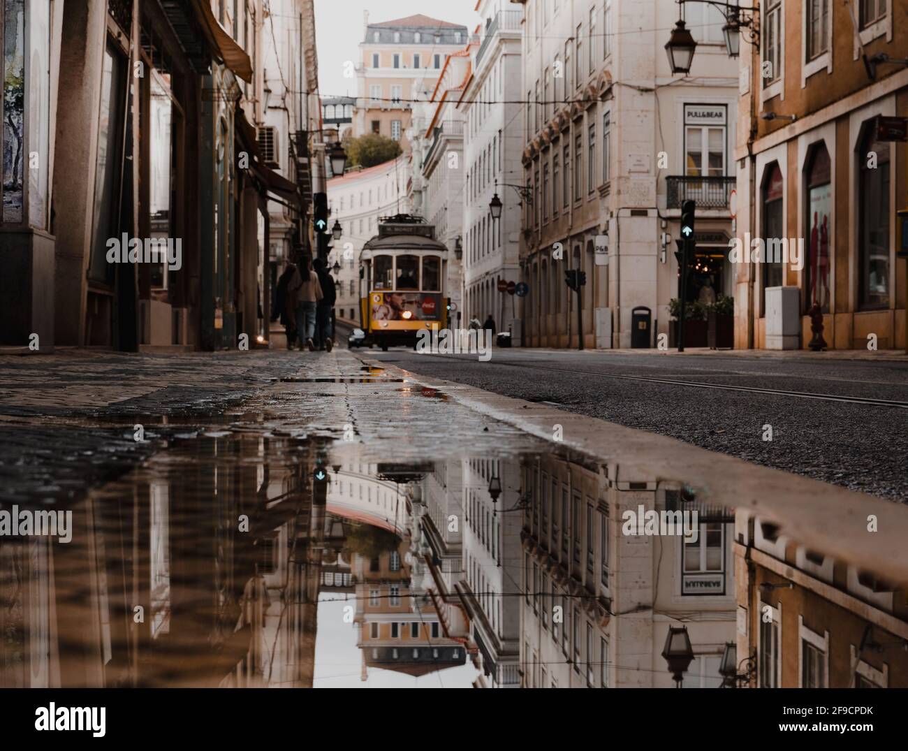 Beautiful shot of a train reflection on the water in the street Stock ...