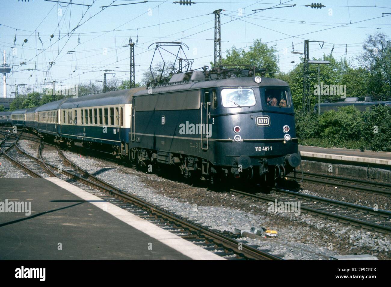 Train headed by DB class 110 electric locomotive, Cologne, North Rhine ...