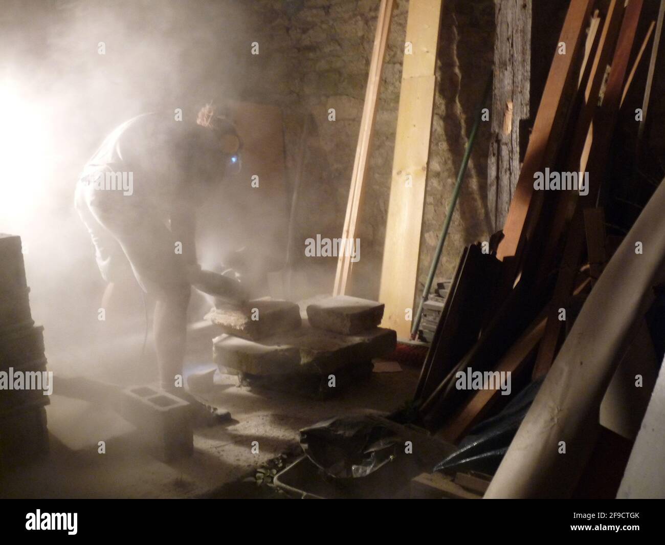 Construction worker cuts cement in a dusty workshop Stock Photo - Alamy