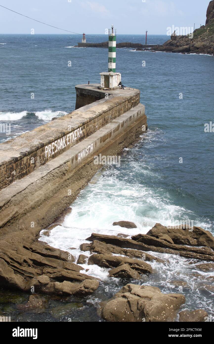 Lighthouse at the entry of a natural port Stock Photo - Alamy