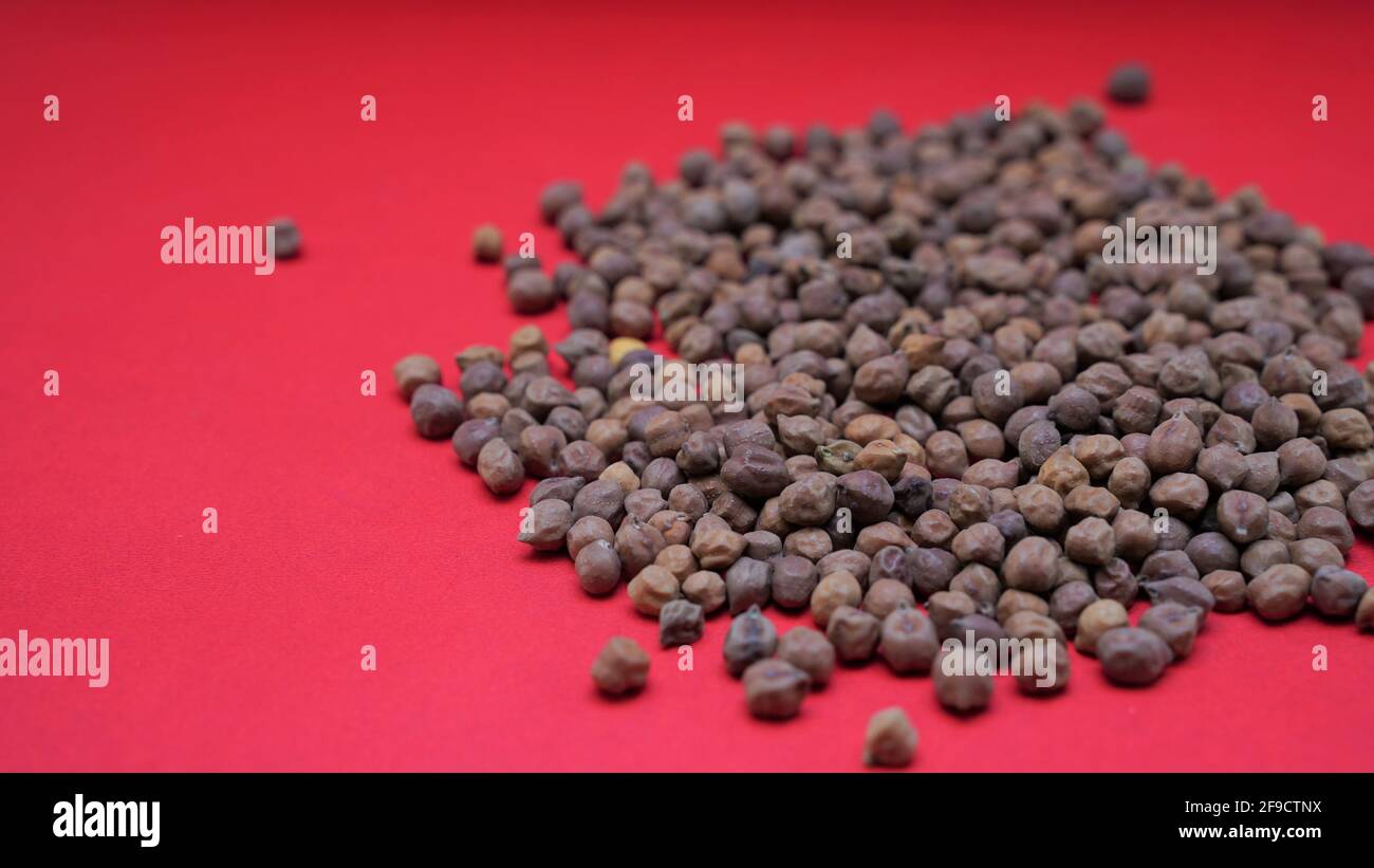 Closeup of black chickpeas on the red surface - space for text Stock ...