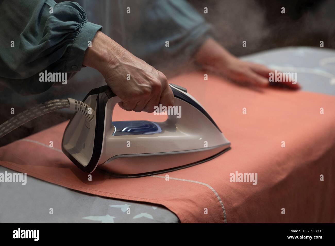 Female ironing clothes hi-res stock photography and images - Alamy