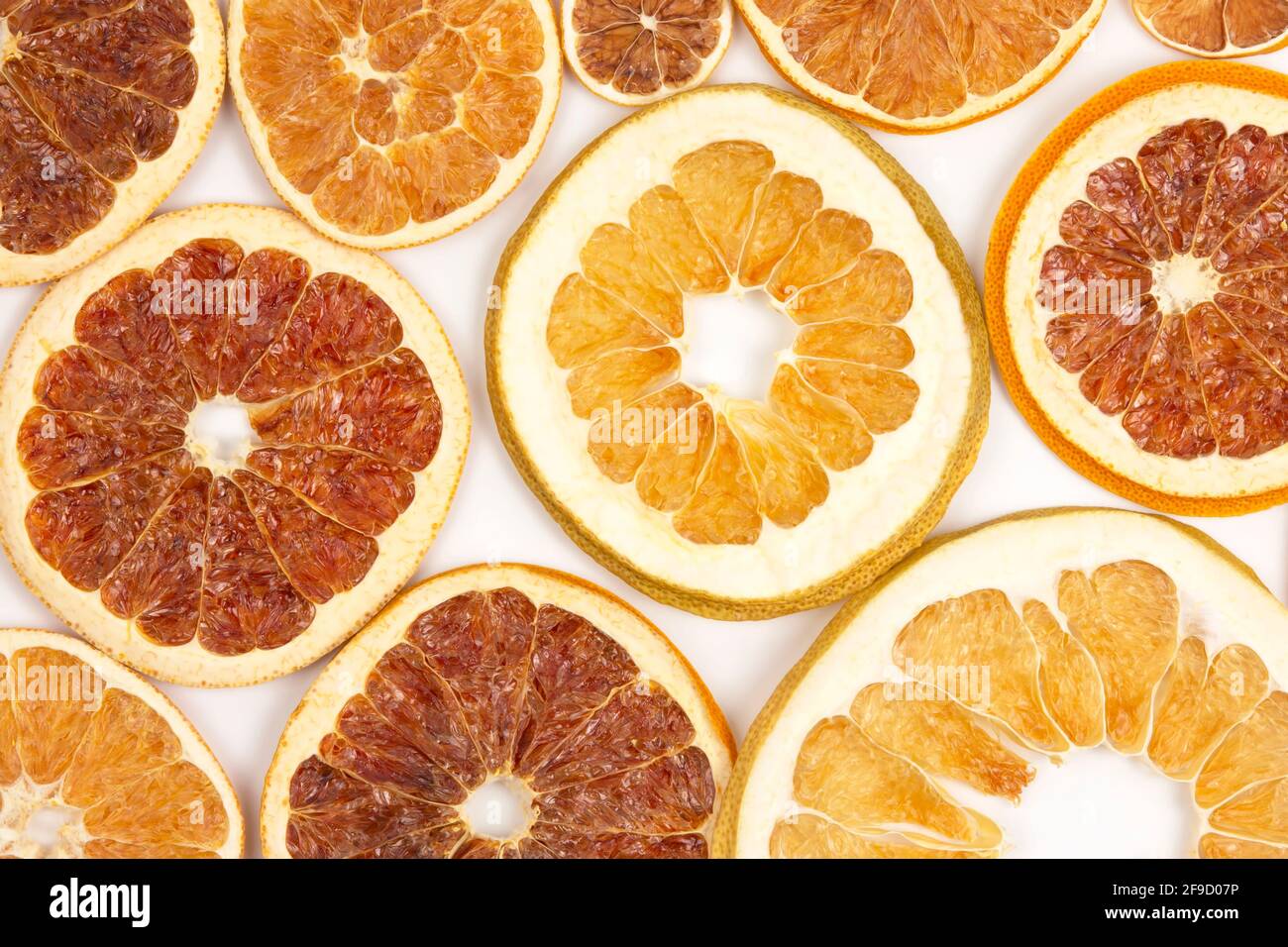 cut pieces of different citrus fruits on white background Stock Photo ...