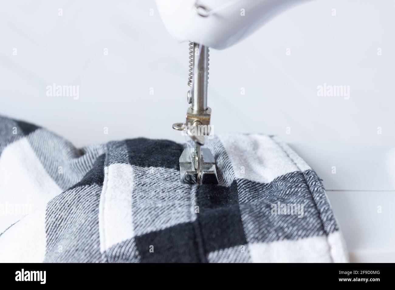 Part of a sewing machine and fabric. Tailor's work, clothing repair ...