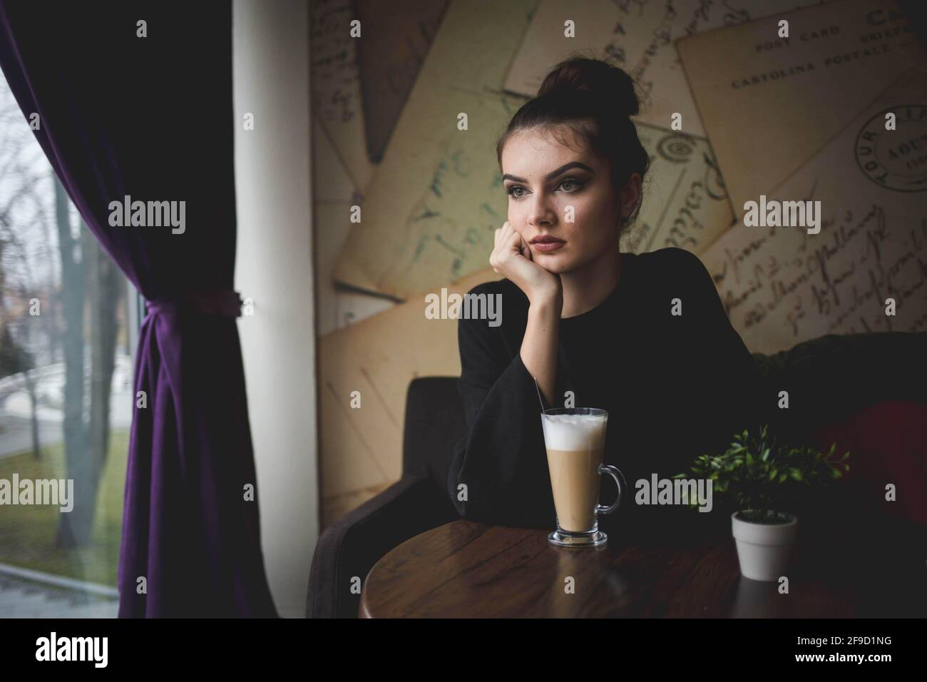 Beautiful Bosnian woman sitting in the cafe and looking out of the ...