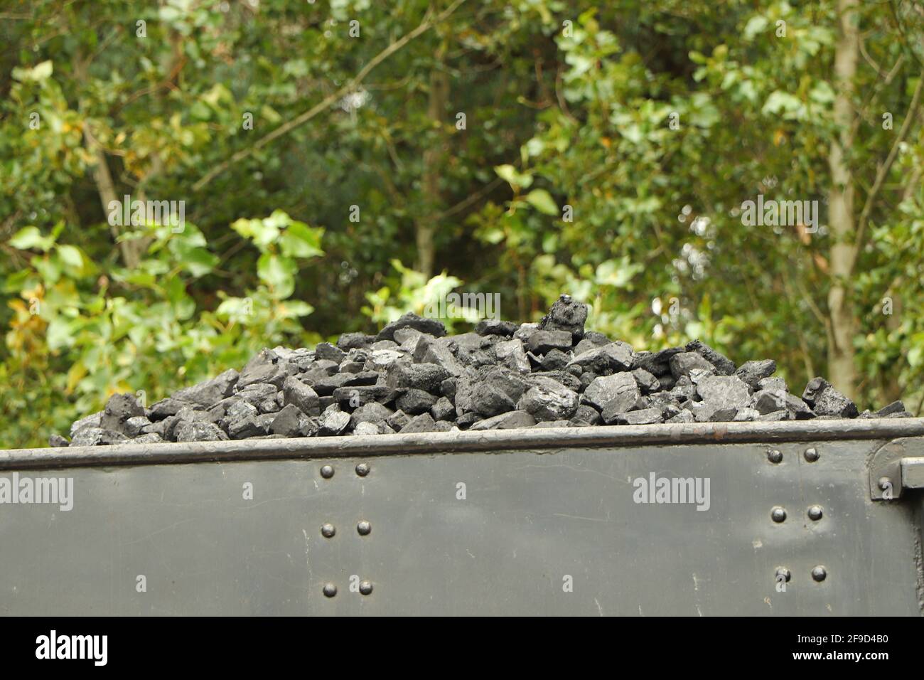 Steam locomotive full of coal running on a track through the ...