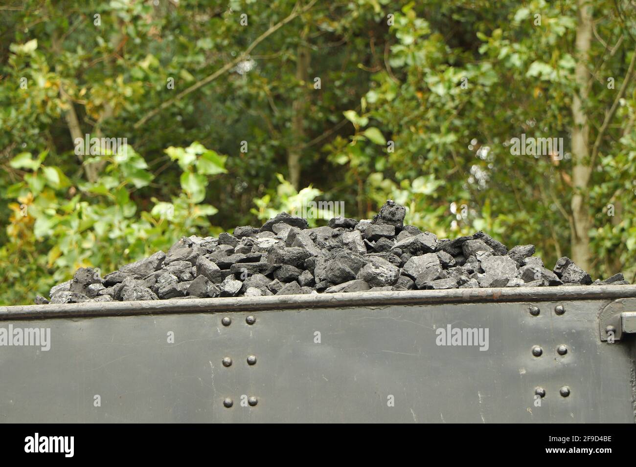 Steam locomotive full of coal running on a track through the ...
