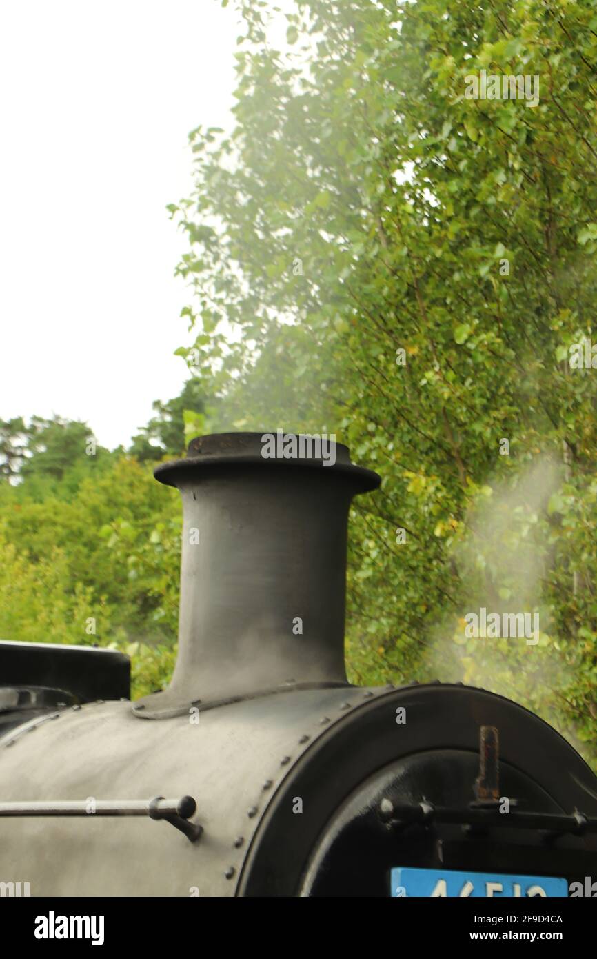 Steam locomotive full of coal running on a track through the ...