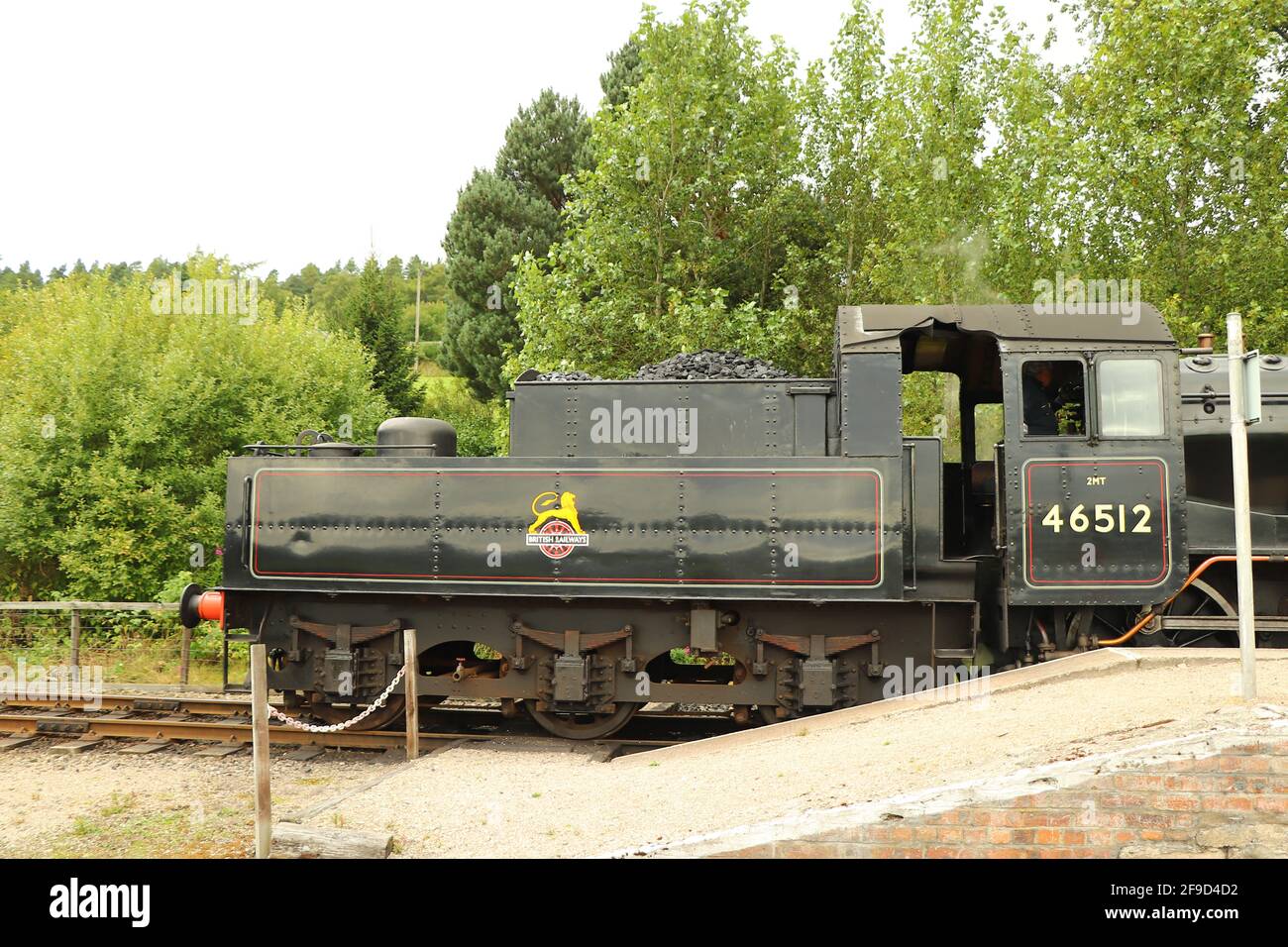Steam locomotive full of coal running on a track through the ...