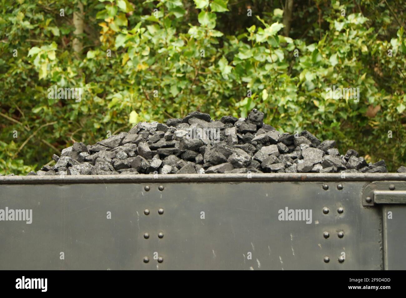 Steam locomotive full of coal running on a track through the ...