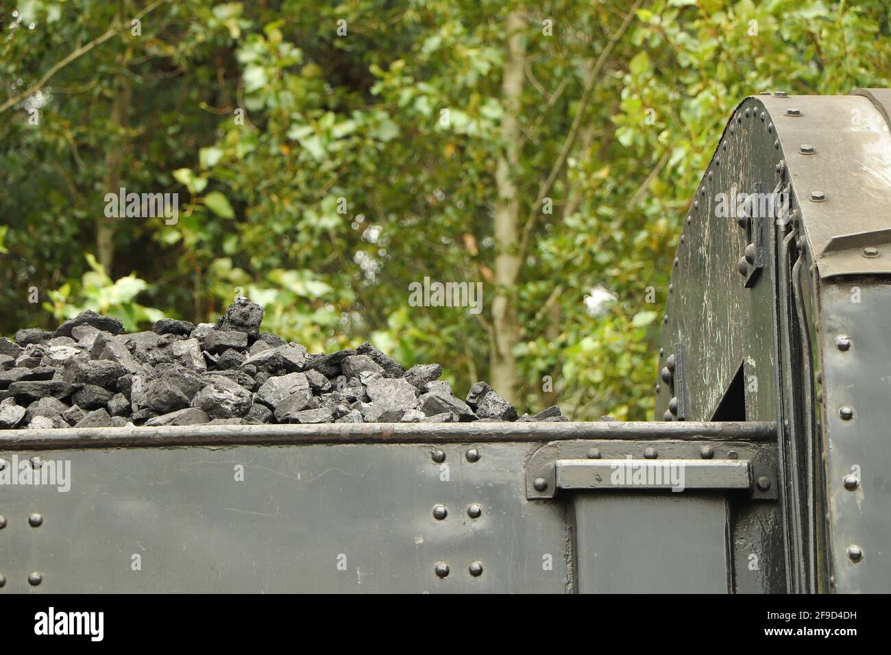 Steam locomotive full of coal running on a track through the ...