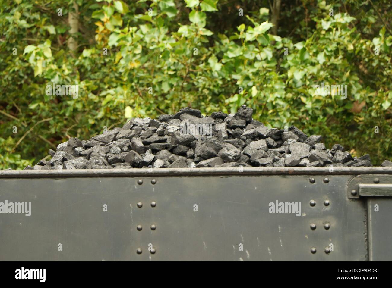 Steam locomotive full of coal running on a track through the ...