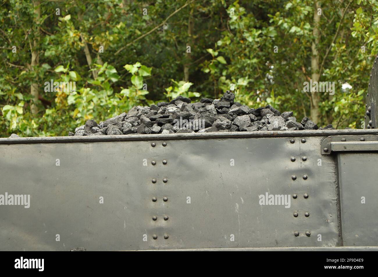 Steam locomotive full of coal running on a track through the ...