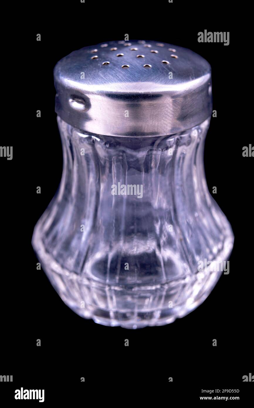 Glass salt shaker with a metal screw cap. A container for storing ...