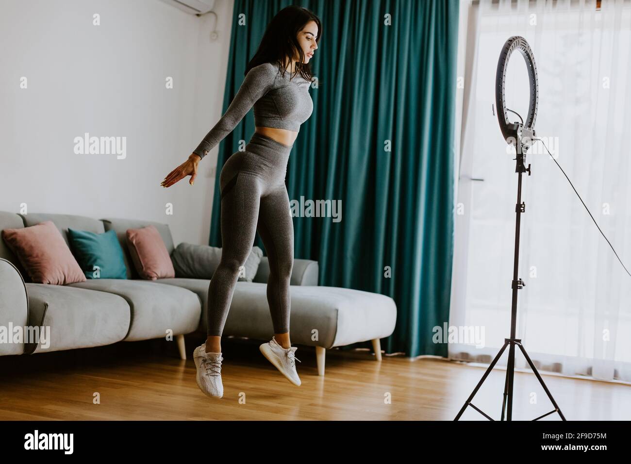 Attractive Woman virtual workout at home using smartphone Stock Photo ...