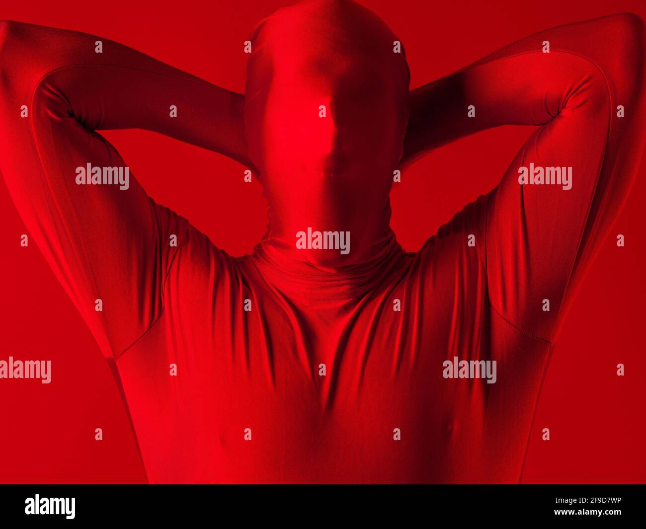 A screaming man in a red full suit, on a red background. The concept of ...