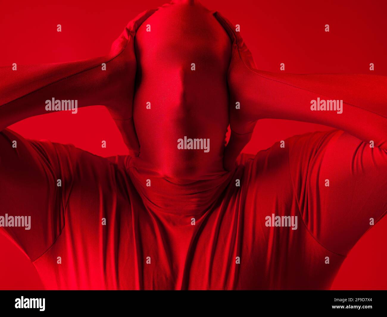 Crazy screaming red man on a red background. figure in a leotard ...