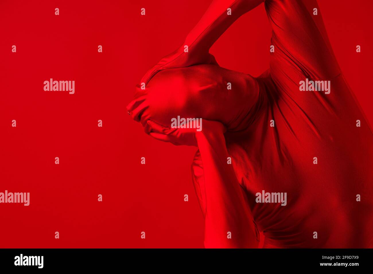 Crazy screaming red man on a red background. figure in a leotard ...