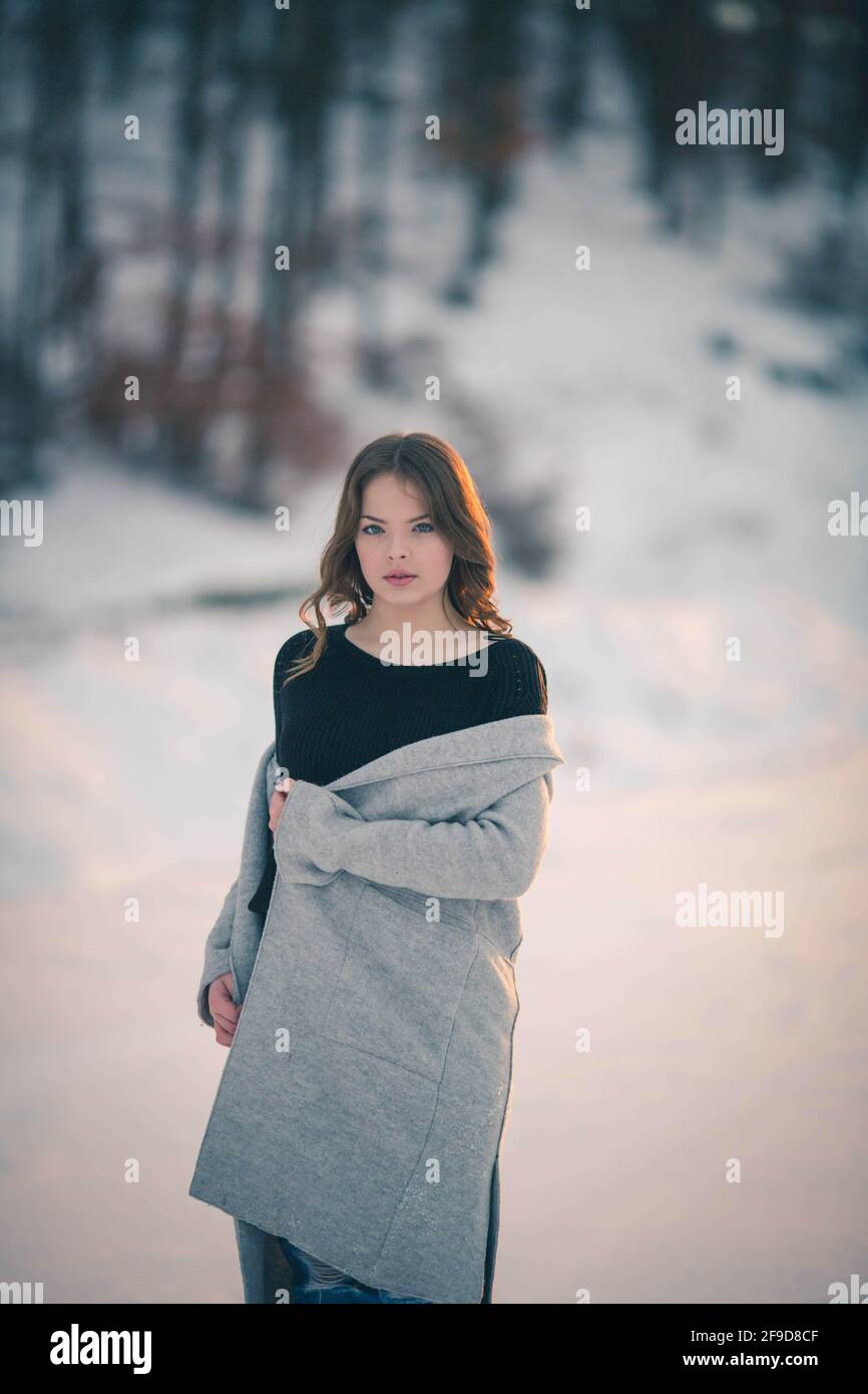 Beautiful Bosnian Caucasian woman in gray coat looking at the camera ...