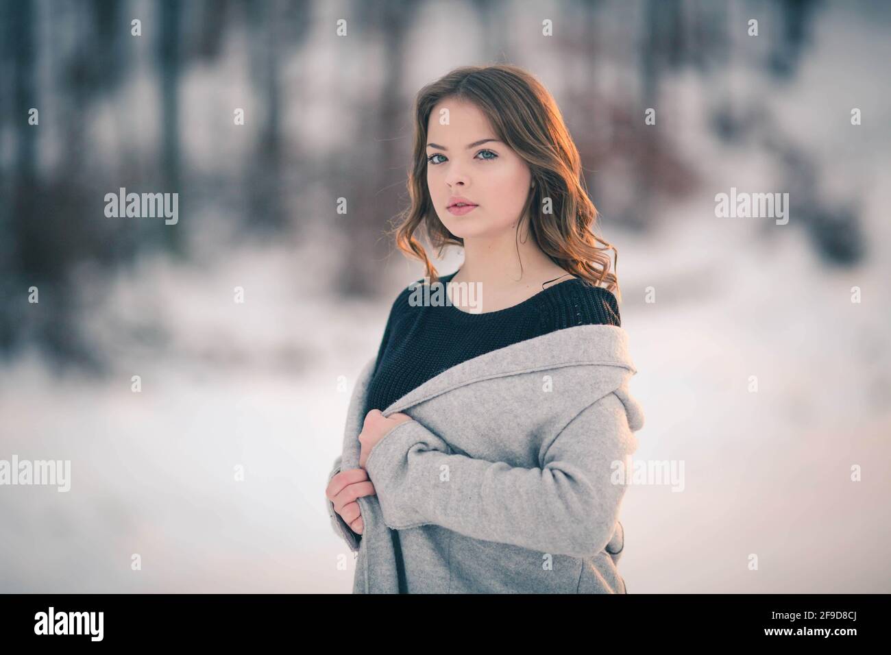 Beautiful Bosnian Caucasian woman in gray coat looking at the camera ...