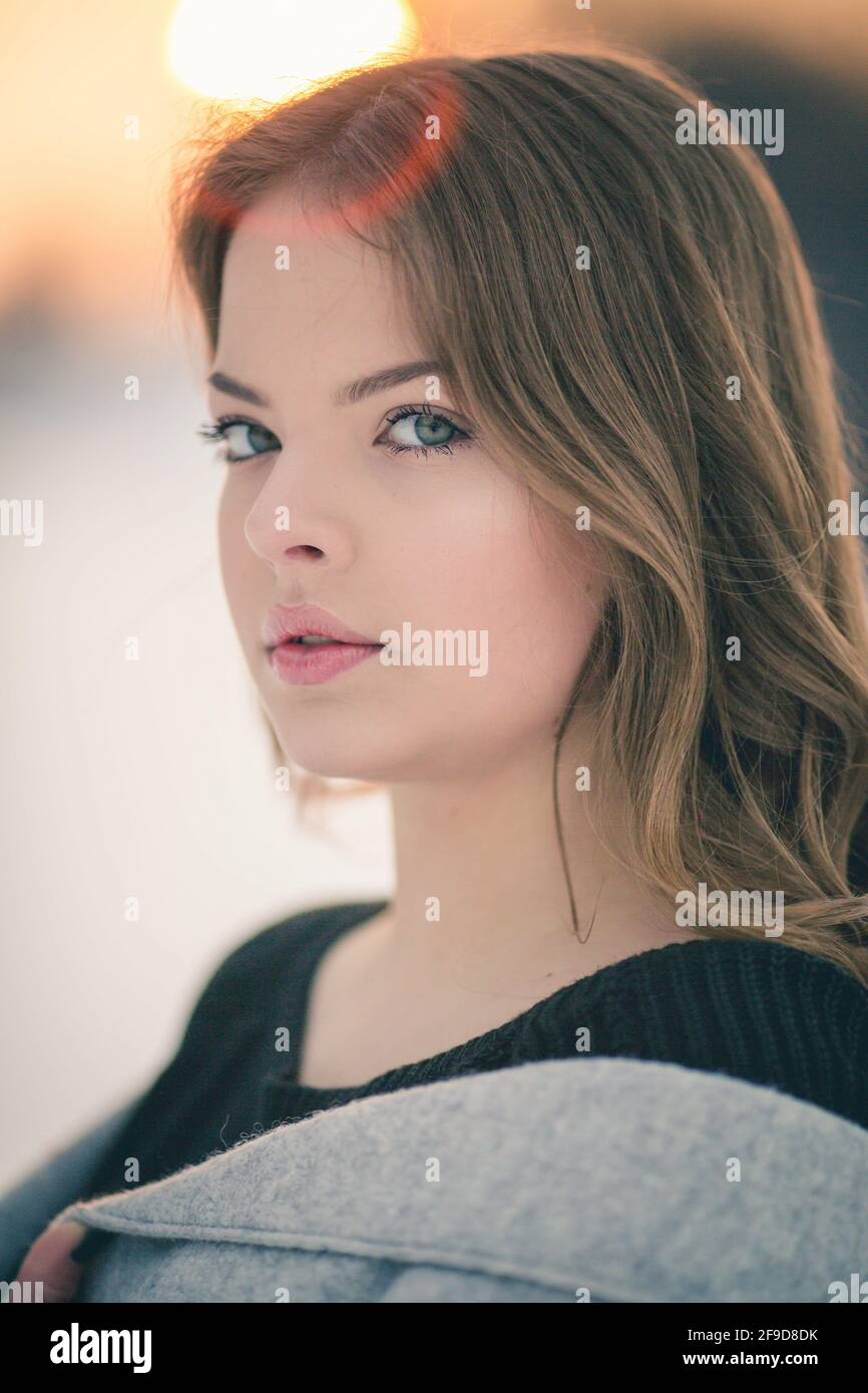 Beautiful Bosnian Caucasian woman in gray coat looking at the camera ...