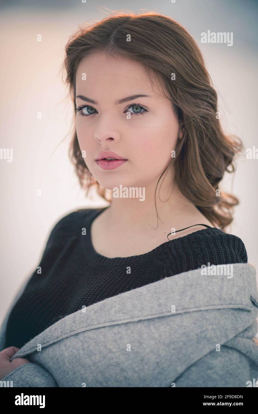 Beautiful Bosnian Caucasian woman in gray coat looking at the camera ...