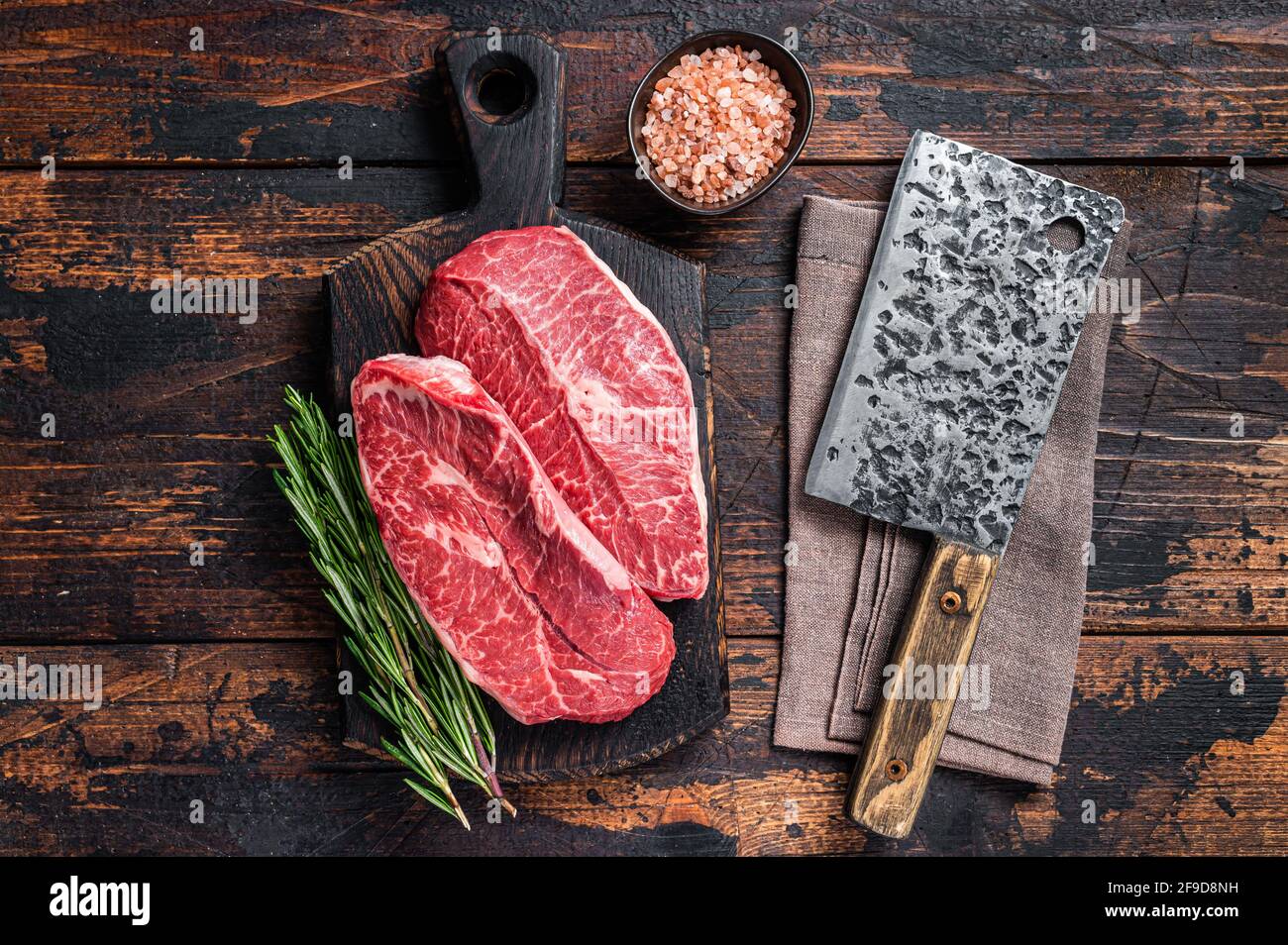 Uncooked Raw Shoulder Top Blade or flat iron beef meat steaks on a ...