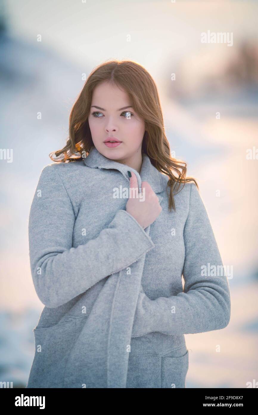 Beautiful Bosnian Caucasian woman in gray coat looking at the camera ...