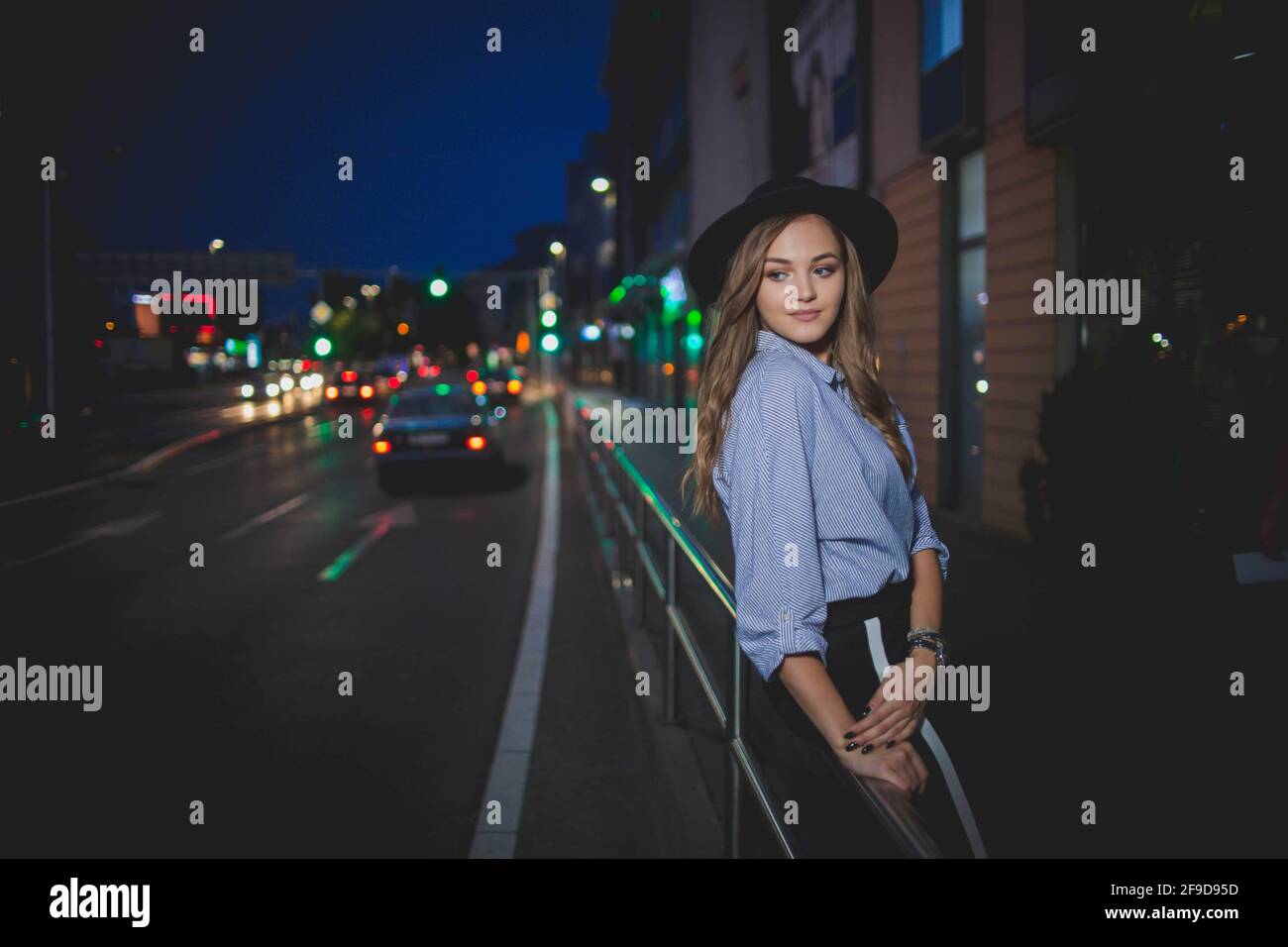 Beautiful Bosnian Caucasian woman in a hat posing in the street during ...