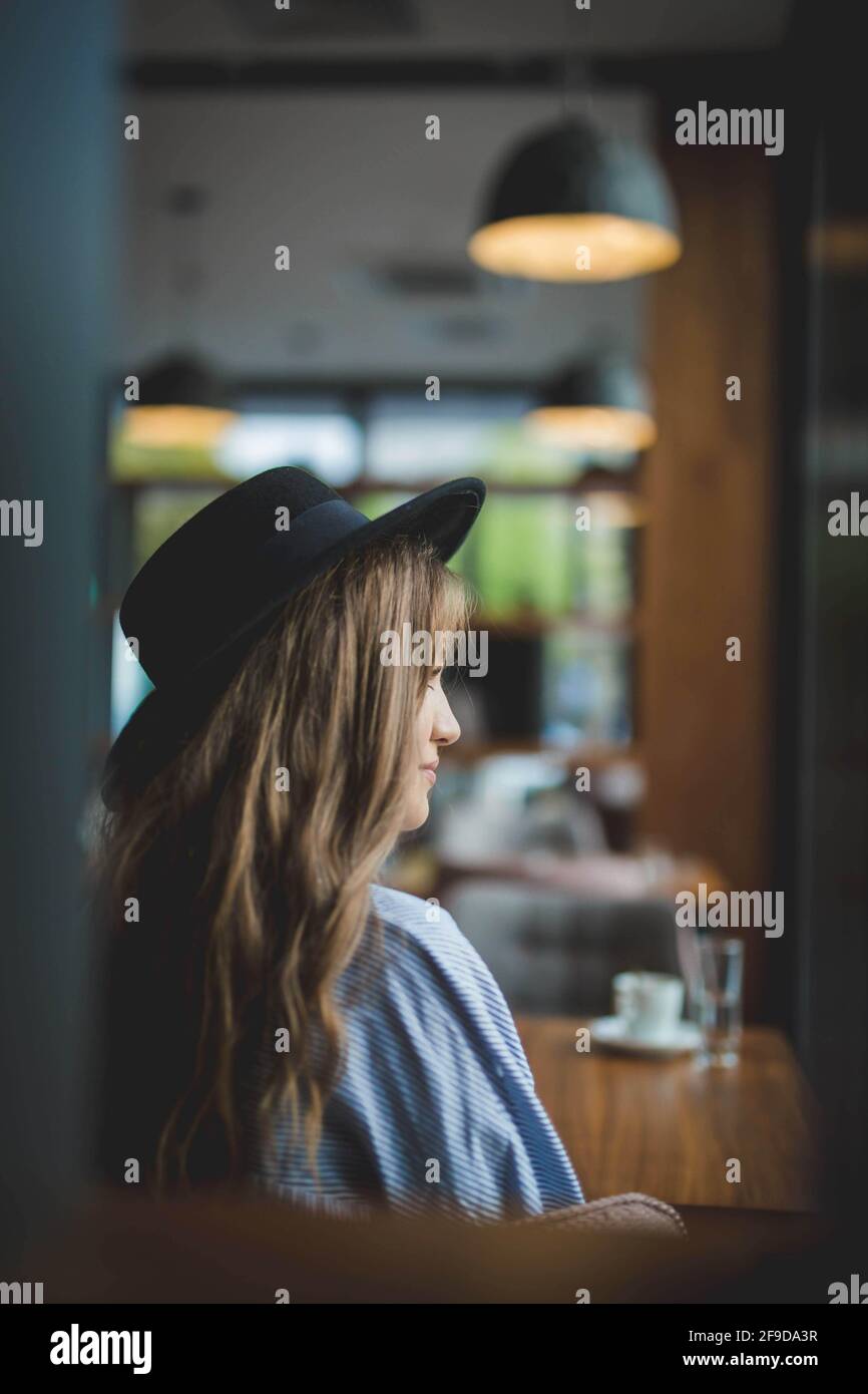 Shallow focus of a young Caucasian woman with long hair wearing a ...