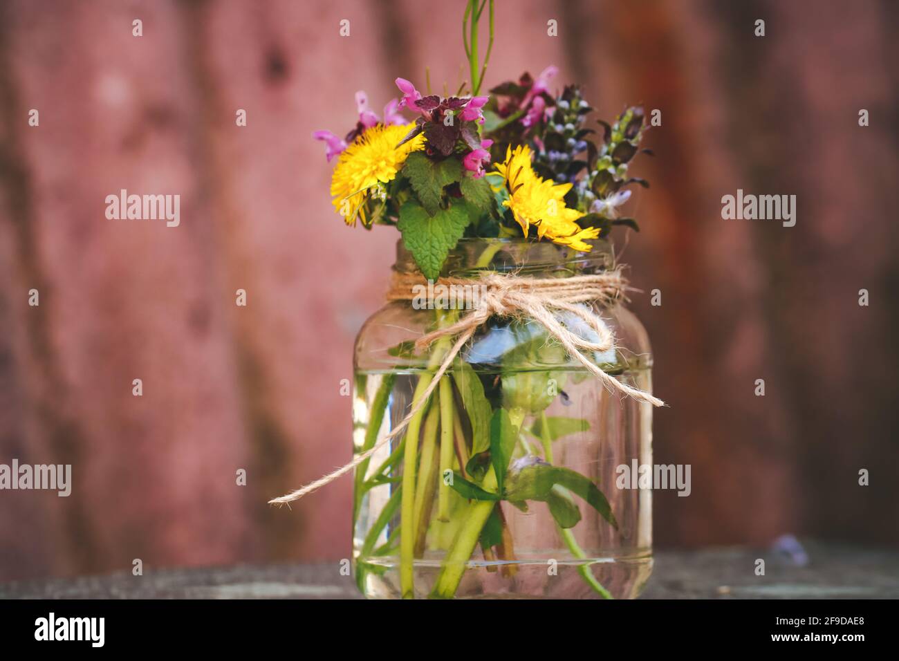 A glass jar with spring flowers Stock Photo - Alamy