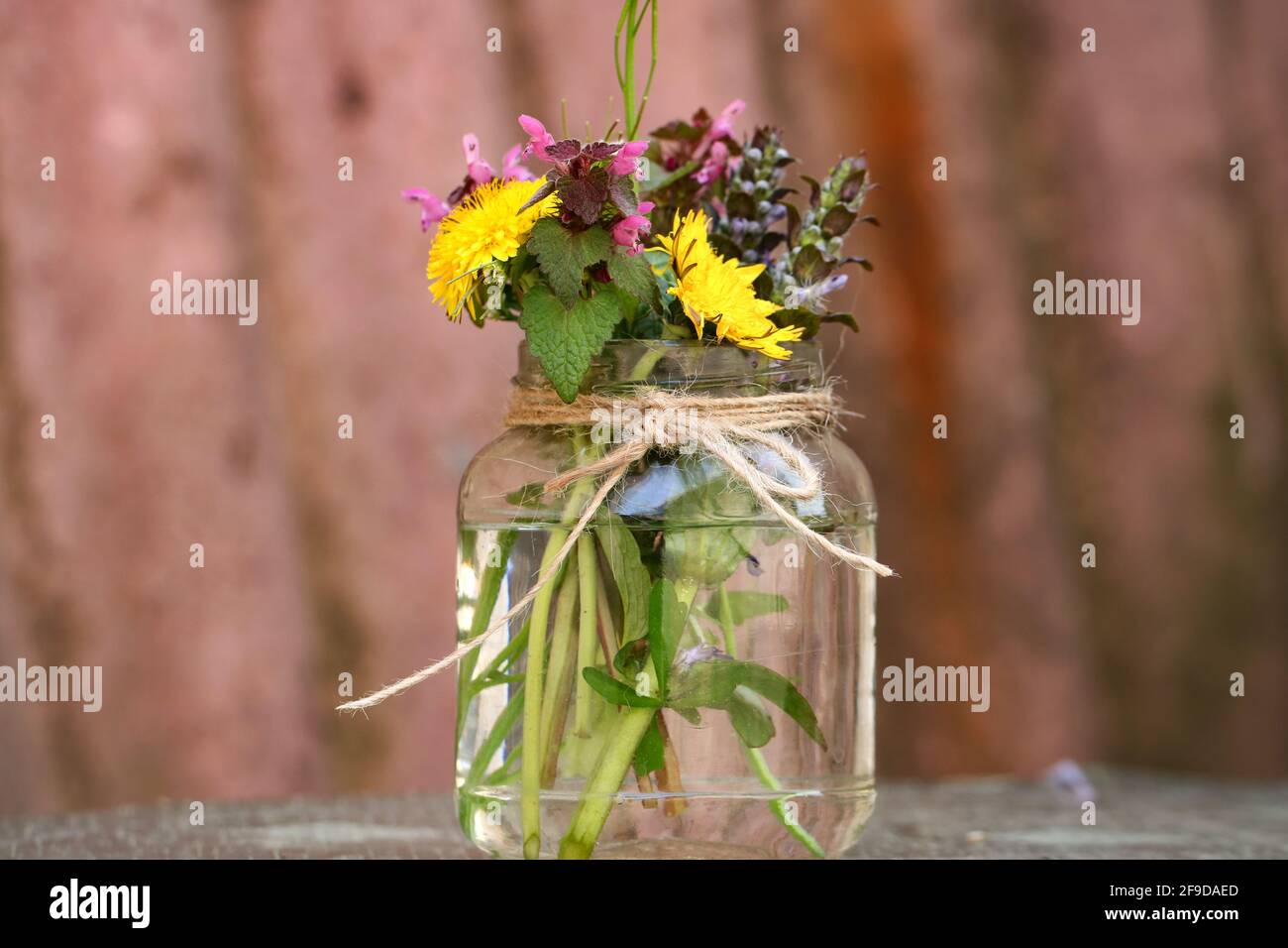 A glass jar with spring flowers Stock Photo - Alamy
