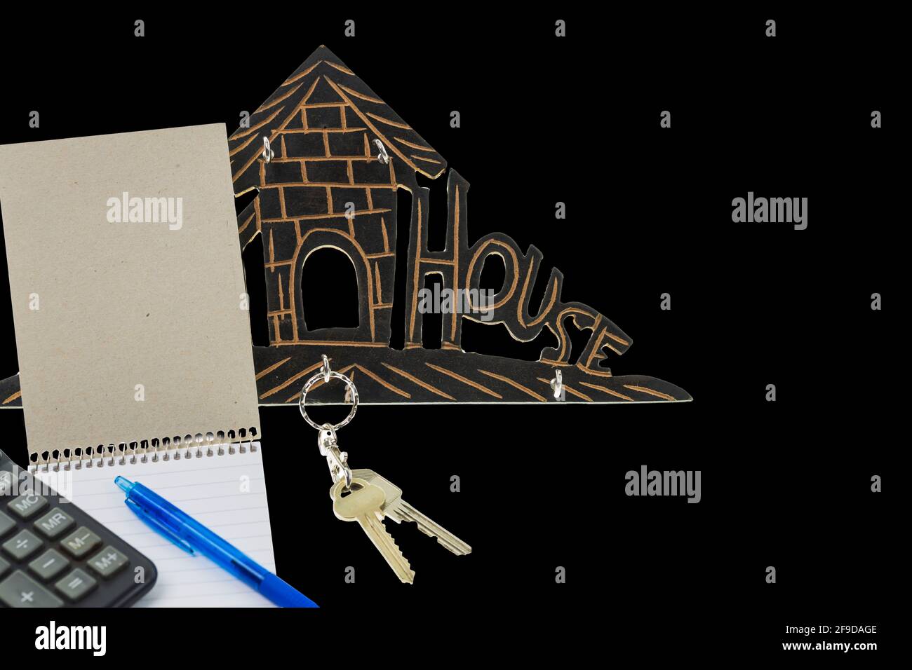 Close up view of buying house symbol with keys on black background ...