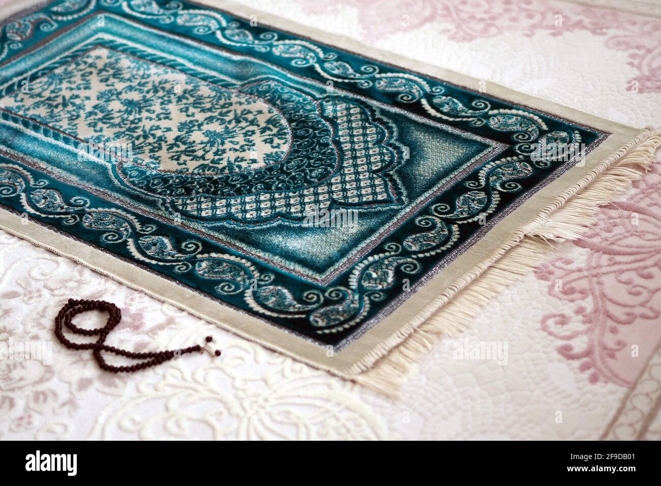 Praying on the prayer rug, which is the prayer rug of Muslims, on the ...