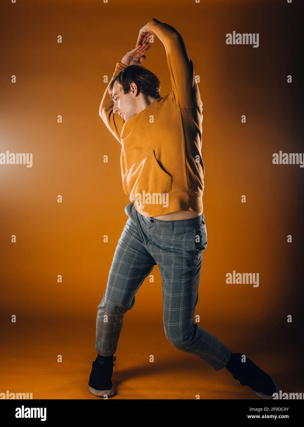 Stylish young man performing an artistic dance choreography Stock Photo ...