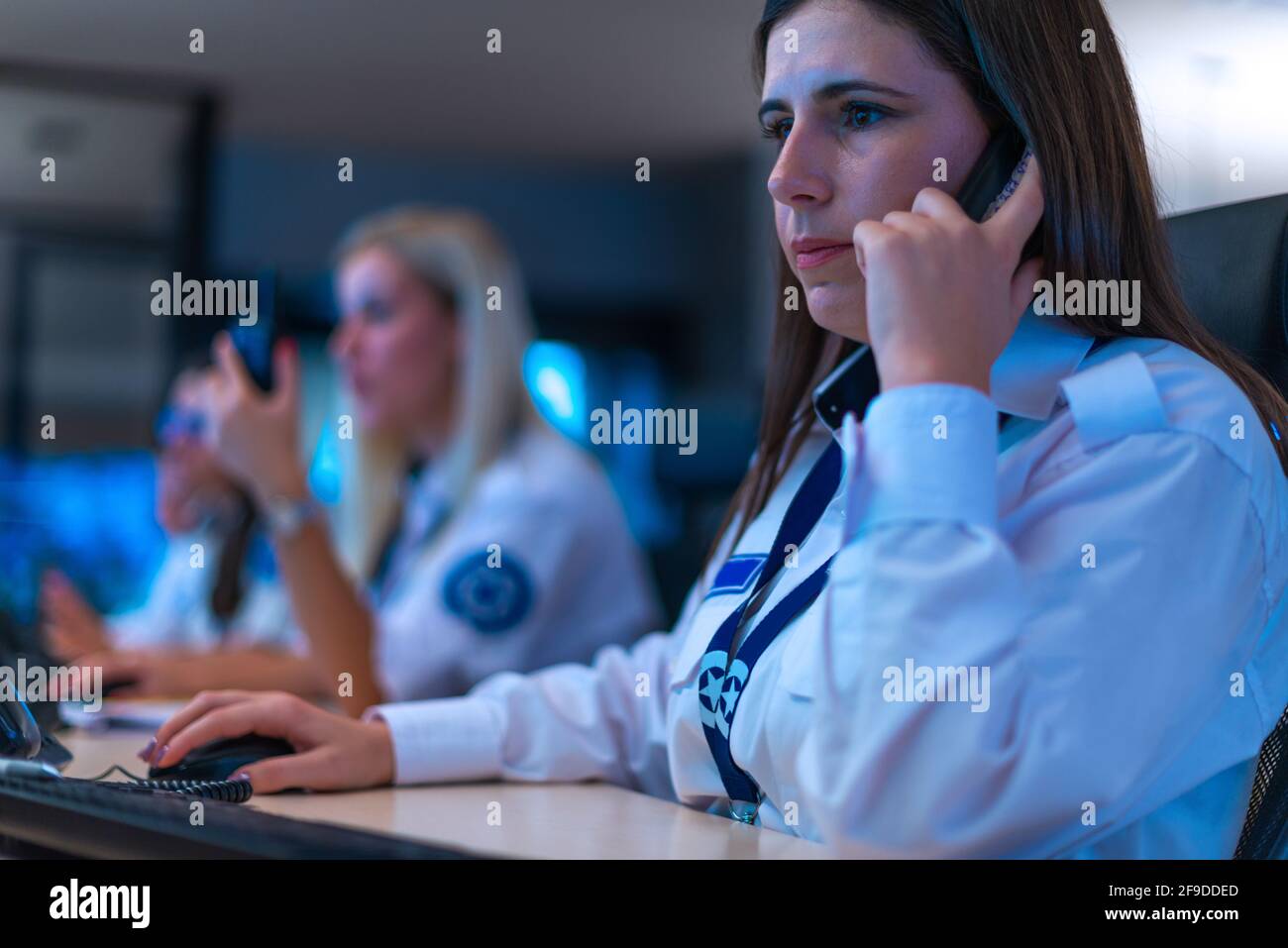 Happy security data center operator colleagues (coworkers) smiling and ...