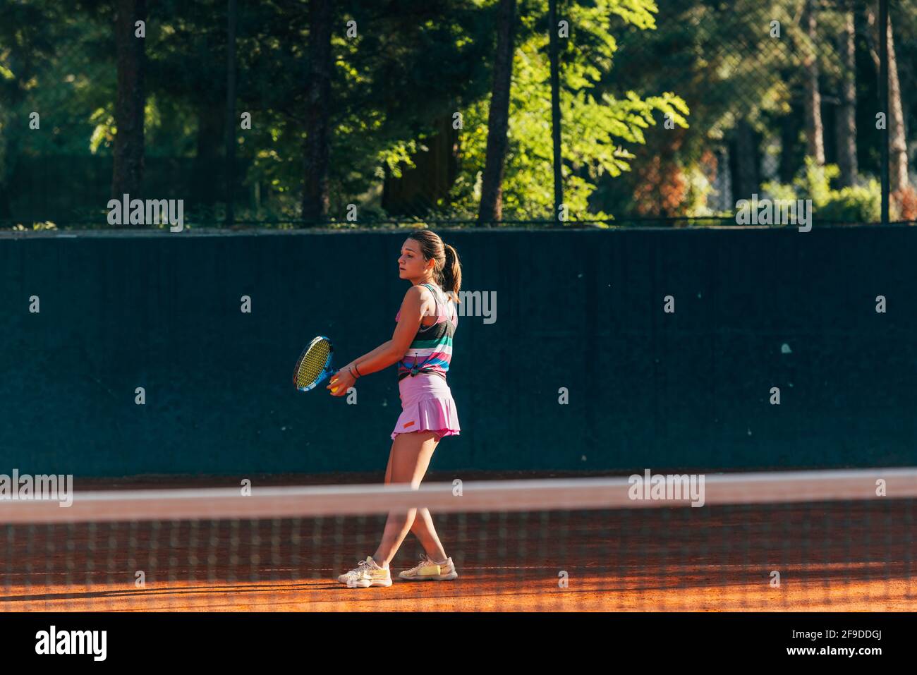 Professional equipped female tennis player serving the tennis ball on a sunny day Stock Photo ...