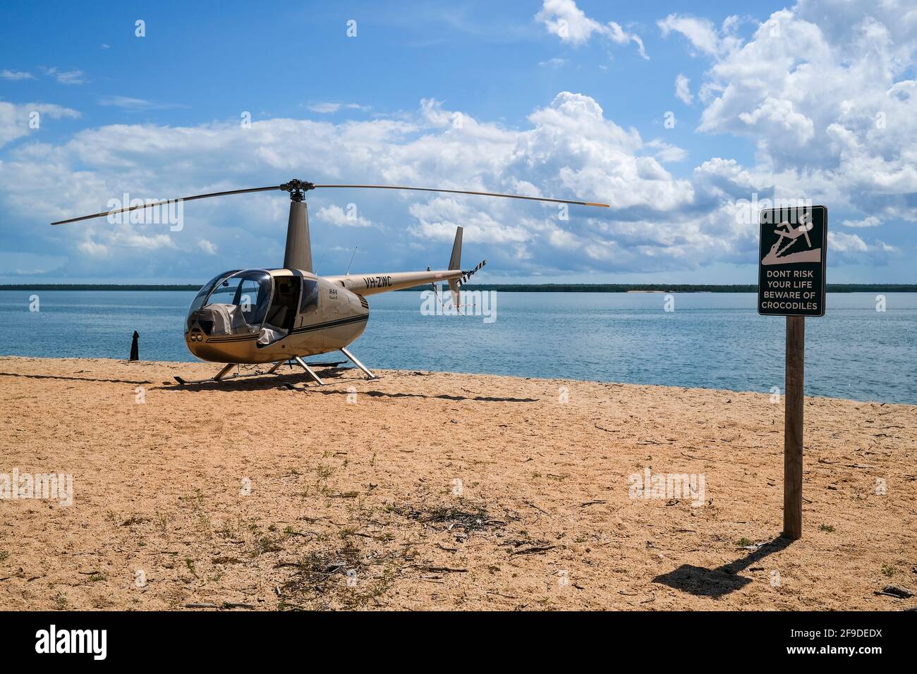Robinson R44 helicopter on the beach of Crab Claw Island Resort in the ...