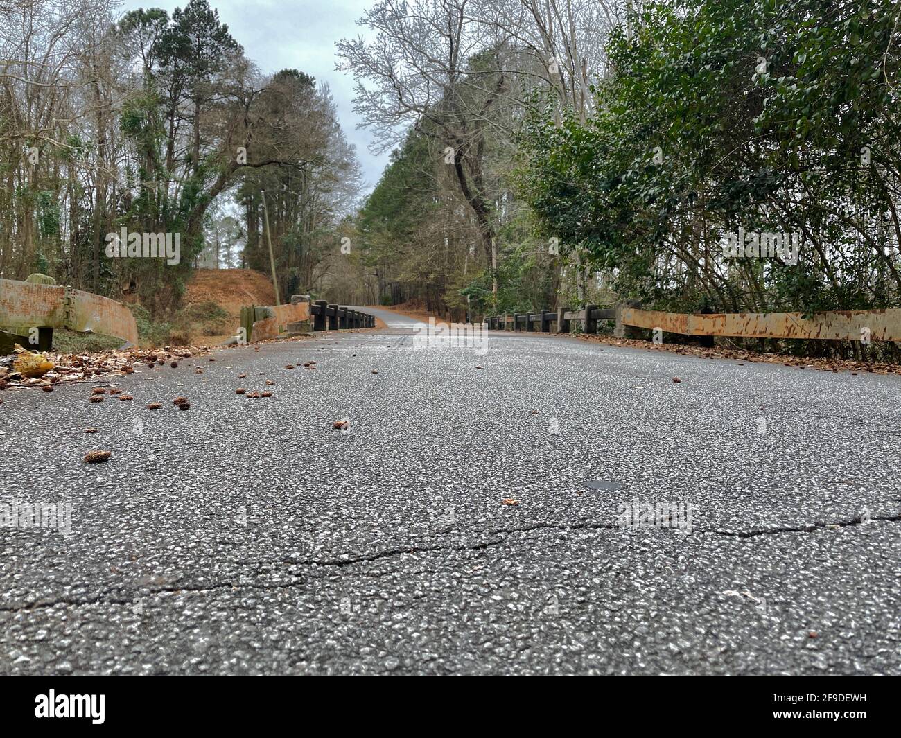 Ground view an old gravel country road with a Concrete bridge in rural ...