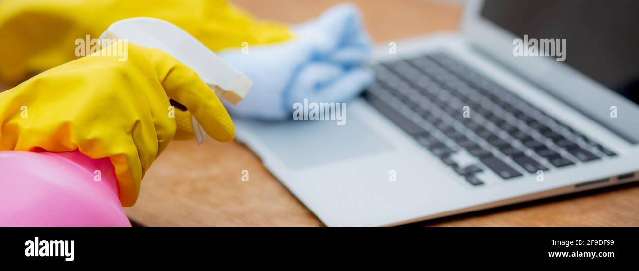 Hand of young asian woman cleaning and wipe laptop computer with ...