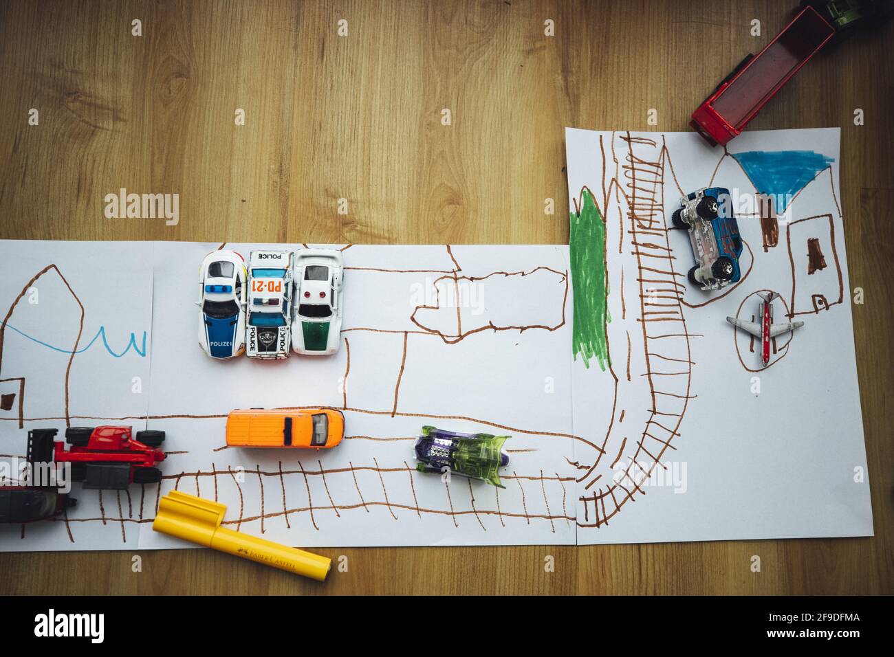 A top view of toy cars on the drawn railroad on white paper Stock Photo ...