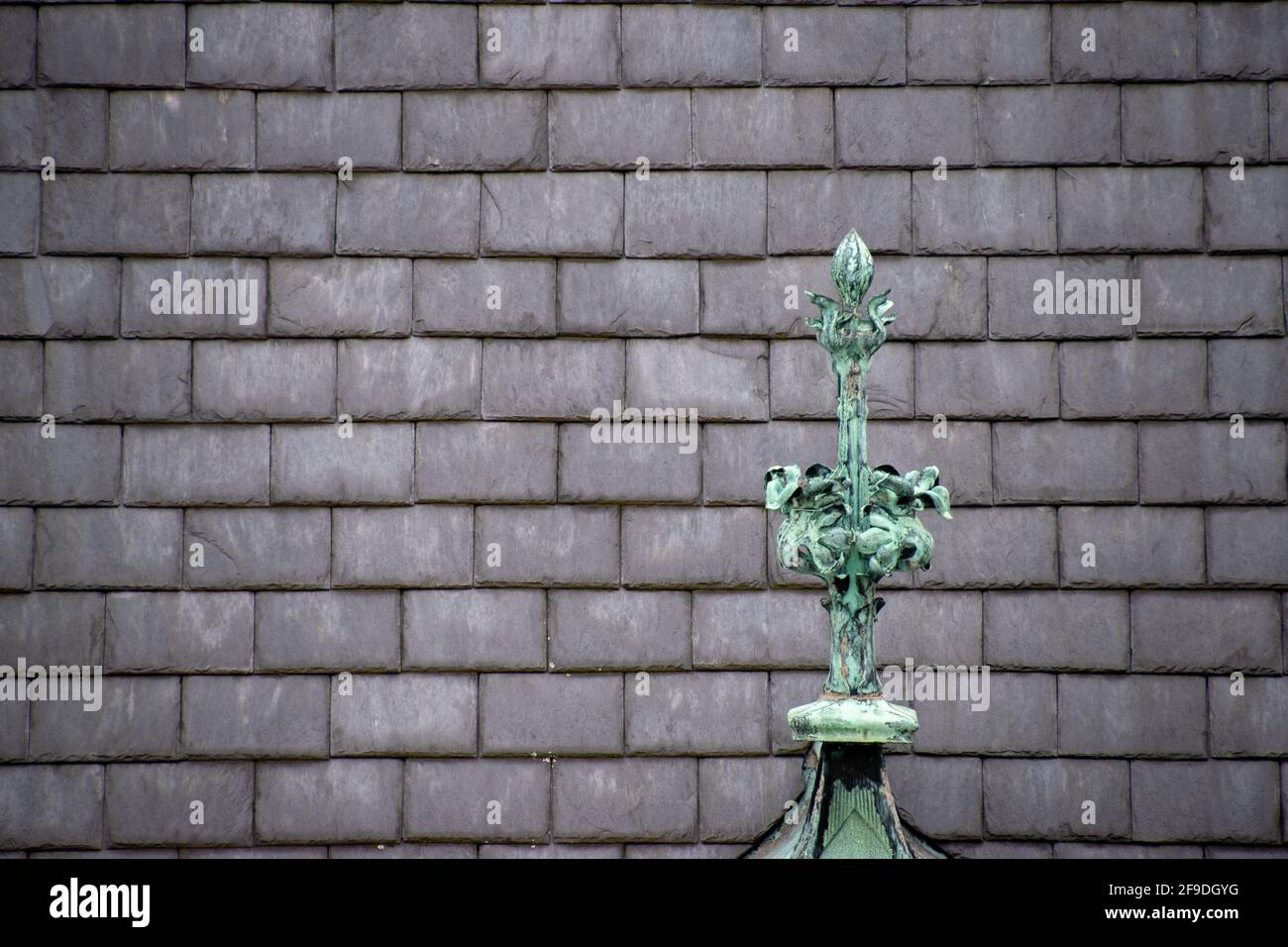 Rectangle grey slate roof shingles with a rooftop copper decoration ...