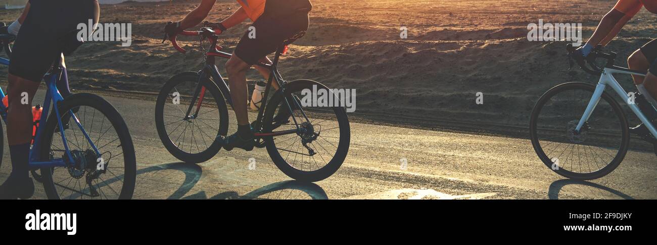 Group of cyclist friends riding race bike on sunset highway, sunset ...