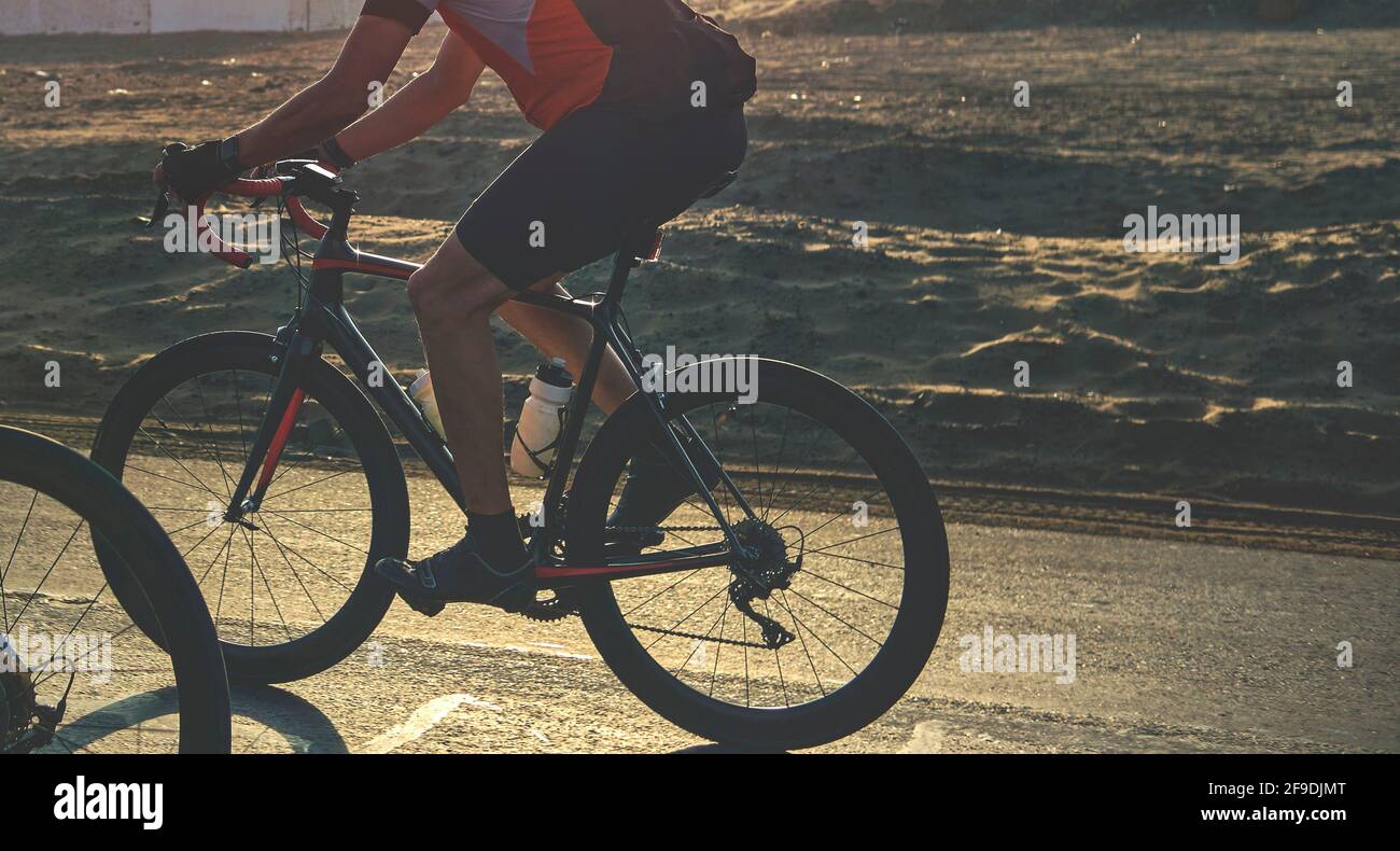 Group of cyclist friends riding race bike on sunset highway, sunset ...