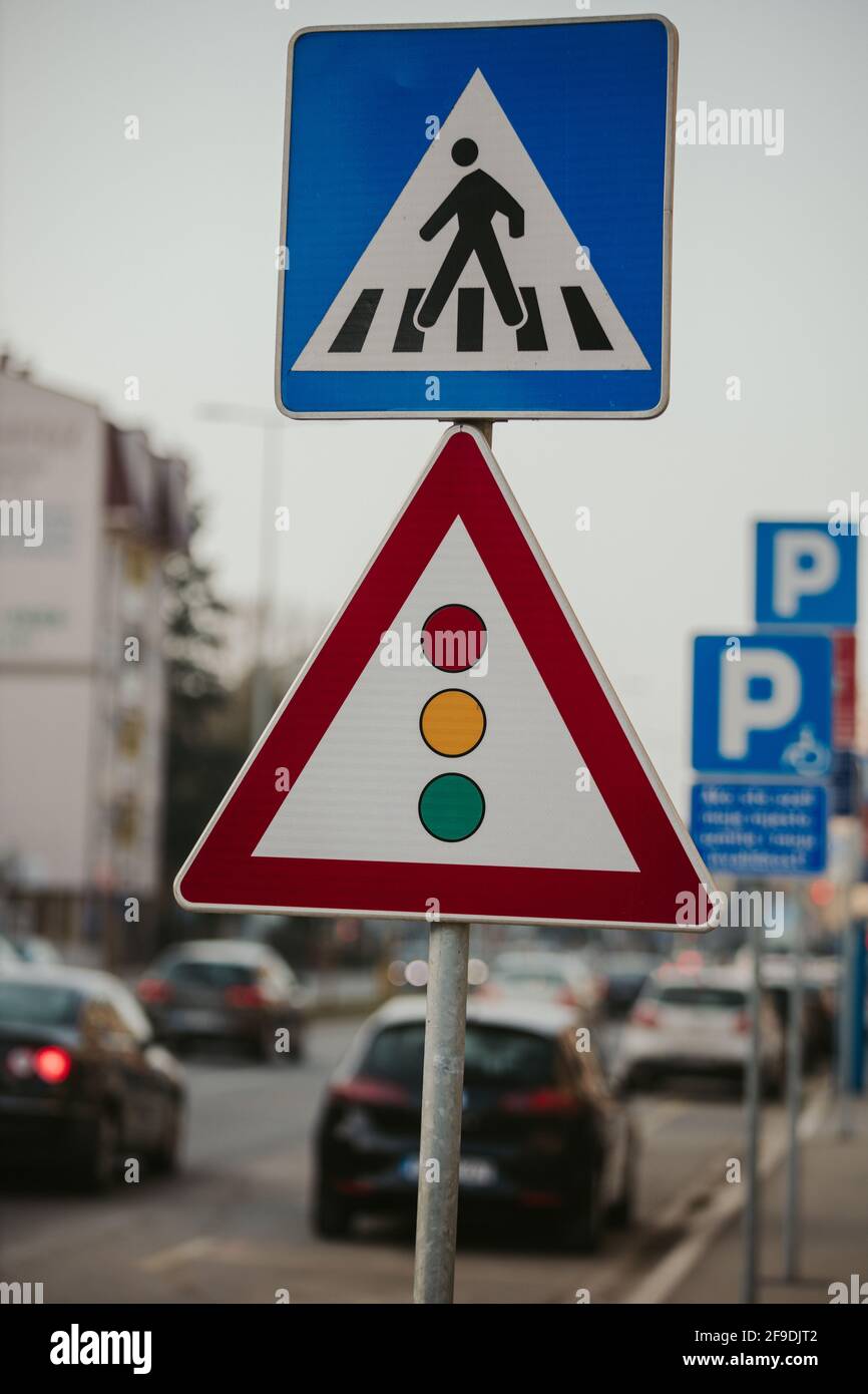 A shallow focus shot of a crossing and traffic light signs during ...